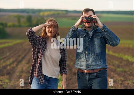 Using binoculars. Lovely beautiful couple are together on the ...