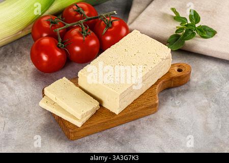 Soya vegan tofu cheese brick over board Stock Photo - Alamy
