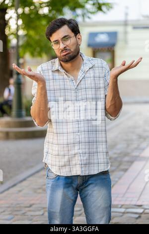I dont know what to say. Confused Indian young man feeling embarrassed ...