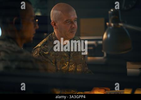 Military personnel engage in discussion to coordinate tasks and ...