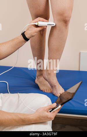 Legs ultrasound examination scan using portable ultrasound machine ...