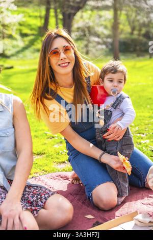 Young mother holding kid baby son. Adorable child boy having fun with ...