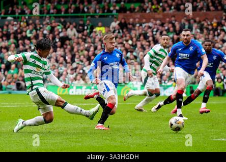 Celtic's Reo Hatate (left) scores his sides first goal during the ...