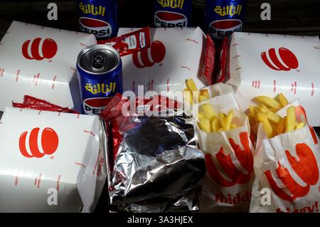 Cairo, Egypt, February 8 2025: Pepsi cans and Wimpy delivery fast food ...