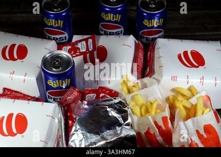 Cairo, Egypt, February 8 2025: Pepsi cans and Wimpy delivery fast food ...