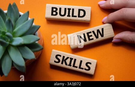 Build New skills symbol. Concept word Build New skills on wooden blocks ...