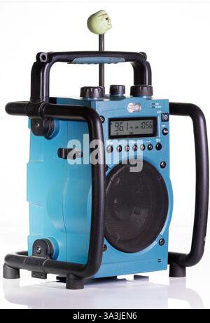 Compact blue radio with visible controls, durable build, and front ...