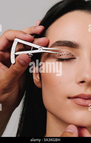Upper blepharoplasty. Plastic surgeon is measuring surgical distance ...