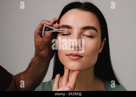 Upper blepharoplasty. Plastic surgeon is measuring surgical distance ...