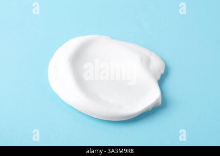 Sample of fluffy foam on light blue background, closeup Stock Photo - Alamy