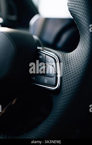 Modern car audio control multifunction buttons on a steering wheel ...
