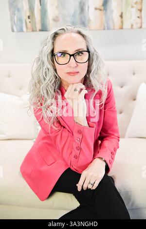 Thoughtful mature woman on pink background Stock Photo - Alamy