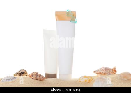 Tubes of sun protection product and small umbrellas on sand against ...