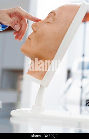 Demonstrating rhinoplasty procedure on a mannequin in the medical ...