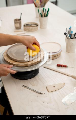 Using sponge for pottery class. Absorbing sponge to get rid of excess ...