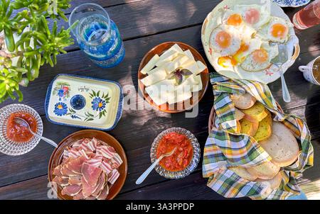 A traditional Balkan breakfast spread with dried meat, cheese, ajvar ...