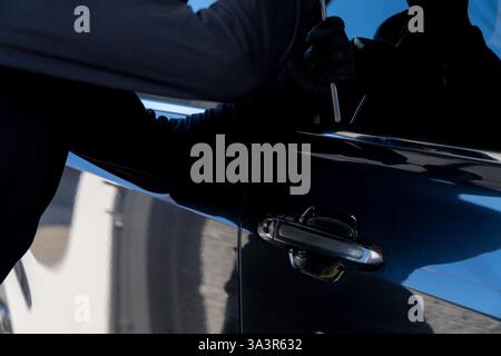Thief in black jacket various action stolen cars Stock Photo - Alamy