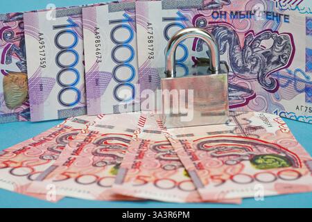 Metal lock and banknotes of Kazakhstani tenge 5000 and 10,000 Stock ...