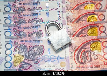Metal lock and banknotes of Kazakhstani tenge 5000 and 10,000 Stock ...