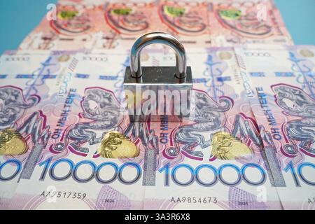 Metal lock and banknotes of Kazakhstani tenge 5000 and 10,000 Stock ...
