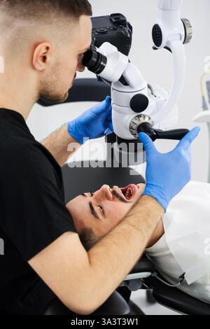Polishing teeth with digital microscope in stomatology clinic. Digital ...
