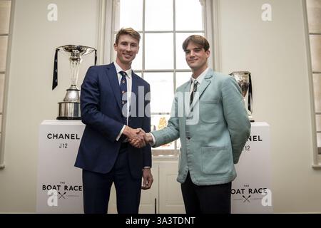 Cambridge Men's President Luca Ferraro lifts the trophy as they ...
