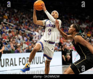 Kansas' Dajuan Harris Jr. drives by Arkansas' Nick Smith Jr. during the ...