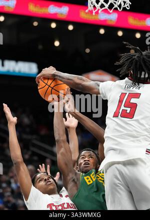 Texas Tech forward JT Toppin (15) turns to drive on Arkansas forward ...