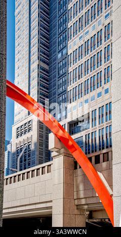 Red steel sculpture and colonnade of the Tokyo Metropolitan Government ...