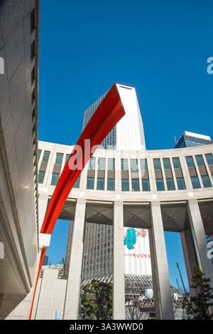 Red steel sculpture and colonnade of the Tokyo Metropolitan Government ...