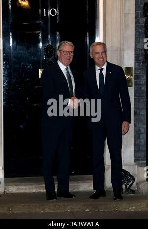 Canada Prime Minister Mark Carney, center, shakes hands with Clerk of ...