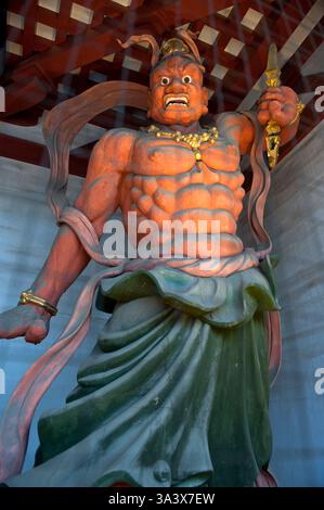 Fierce expression of gate guardian statue with open mouth at Shitennoji ...