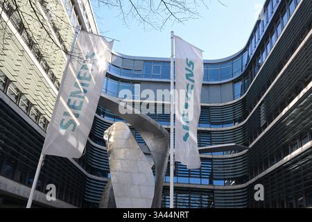 Munich, Germany. 18th Mar, 2025. Zoom effect: Flags with the inscription "Siemens" fly at the ...