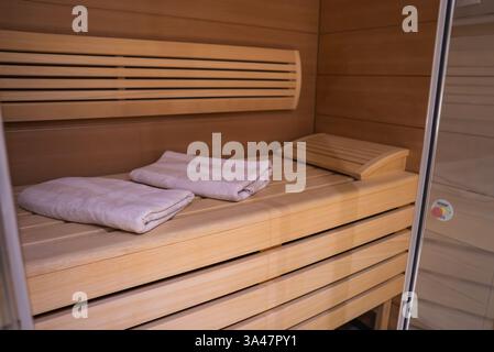 modern luxury sauna interior featuring multi-tier wooden benches and ...