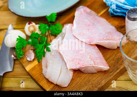 Raw rockfish fillet with condiments, food preparation Stock Photo - Alamy