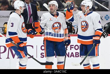 New York Islanders' Tony Deangelo (77) fights for control of the puck ...