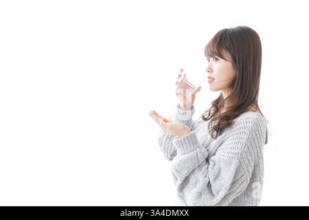 Woman taking tablets/supplements Stock Photo - Alamy