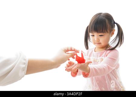 Child holding origami of vine Stock Photo - Alamy