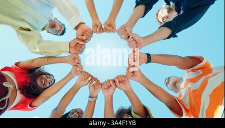 Below, students and fist hands in group for support, motivation or ...