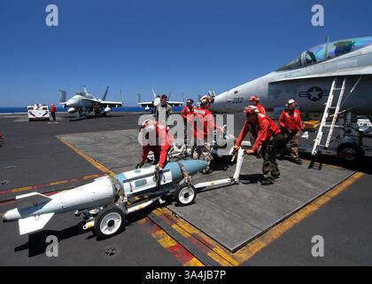 Aviation ordnancemen from Fighter Squadron 21 (VF-21) use a linkless ...