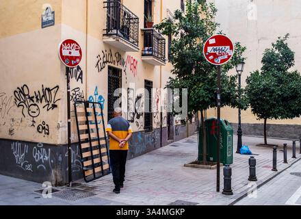 Covered narrow alley with graffiti on the walls and a pylon at the ...