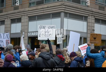 People with signs at a Stop the Cuts rally against DOGE cuts to federal ...