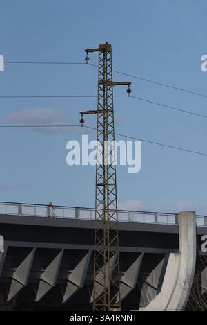 A single electricity pylon in front of a wide sky at dusk, quiet scene ...