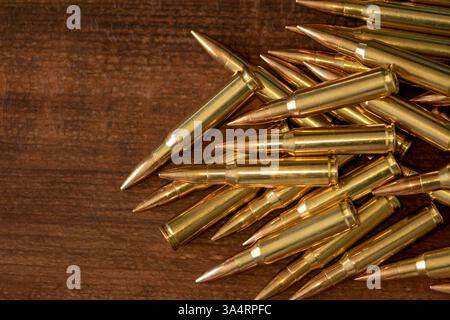 Gun with ammunition on wooden background Stock Photo - Alamy