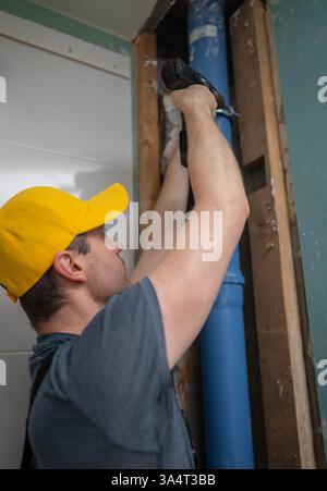 A man installing a new sewer drain stack Stock Photo - Alamy