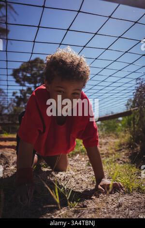 people crawling net boot camp obstacle course Stock Photo - Alamy