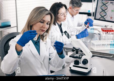 Scientists working with samples at table in laboratory, closeup Stock ...