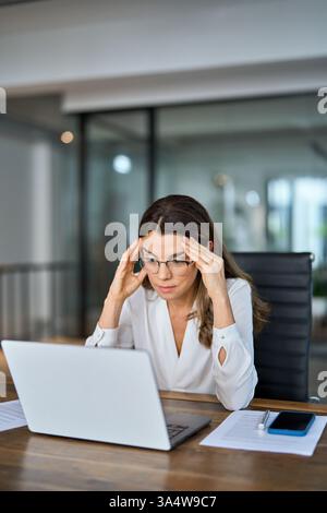 Middle age mature woman wearing christmas hat over isolated background ...