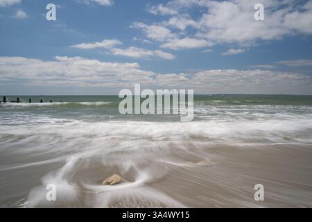 Calm tide on stone beach Stock Photo - Alamy