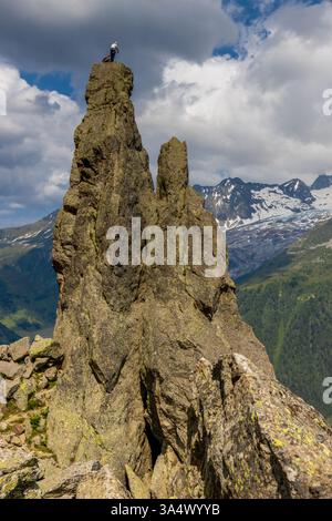 Alpinists climbing granite mountain walls in the Alps. Difficult alpine ...